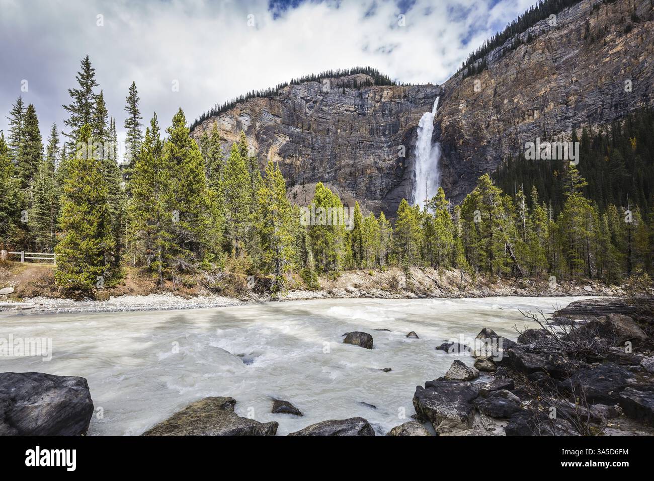 Colossal Takakkaw waterfall formed by melting glacier Daly. Autumn day ...