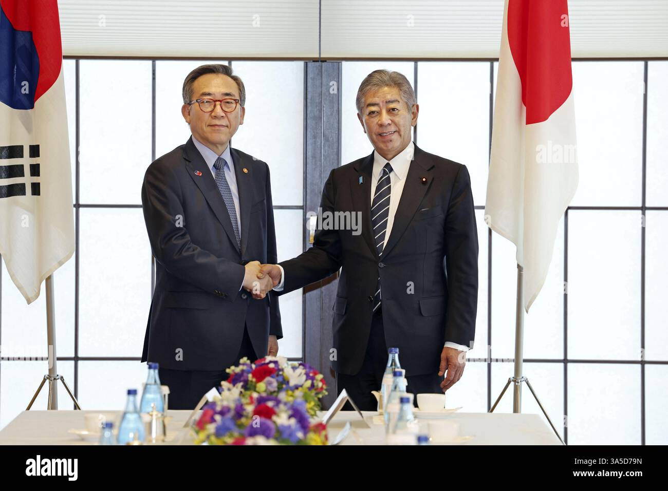 Japanese Foreign Minister Takeshi Iwaya (R) shakes hands with his South ...