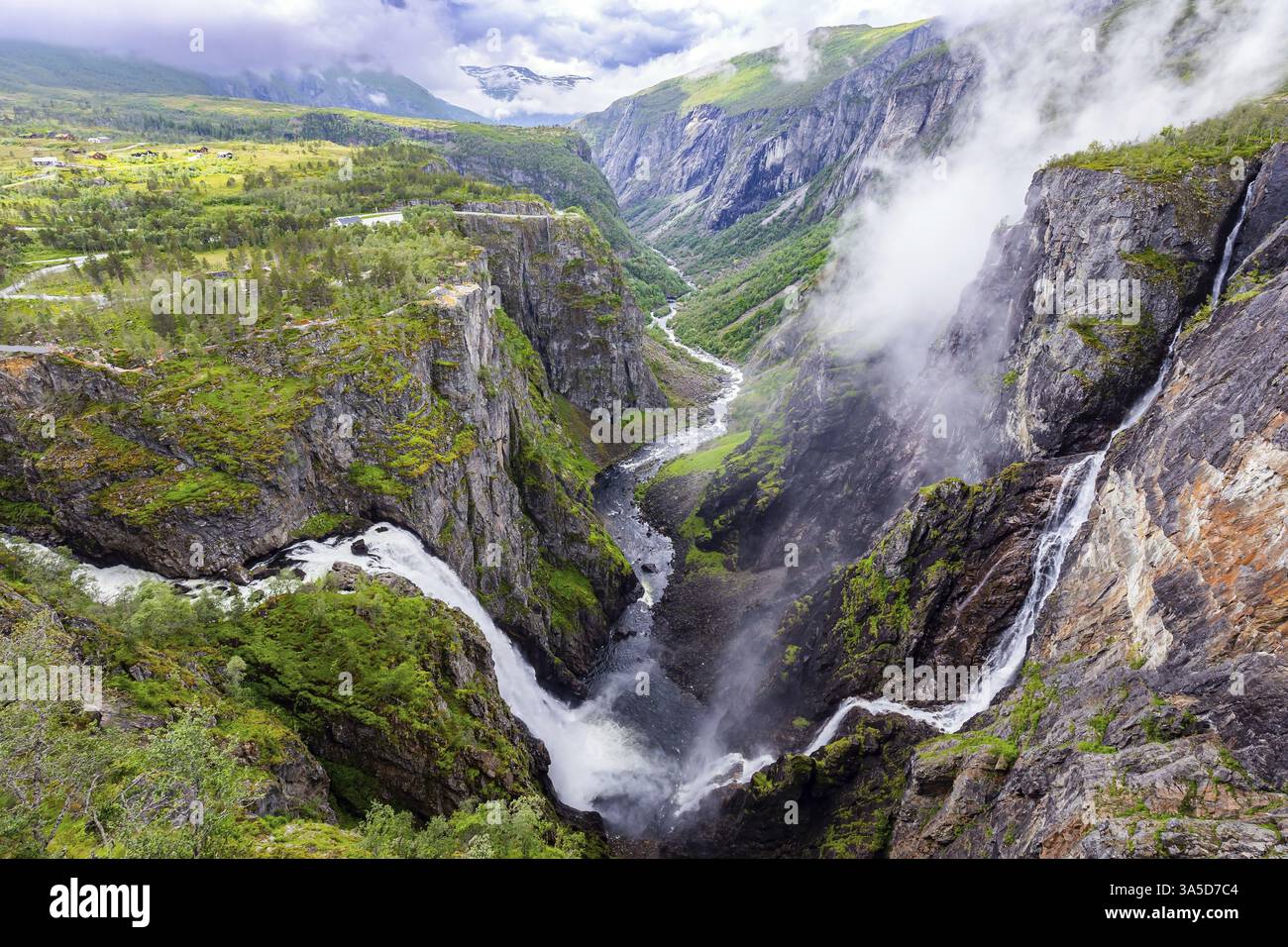 Rainy cold July in Norway. Vaeringsfossen is one of the most famous ...