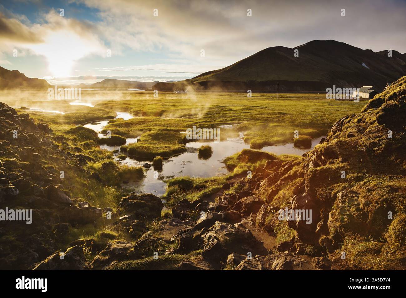 Above the source of thermal water steam rises. White nights in Iceland ...