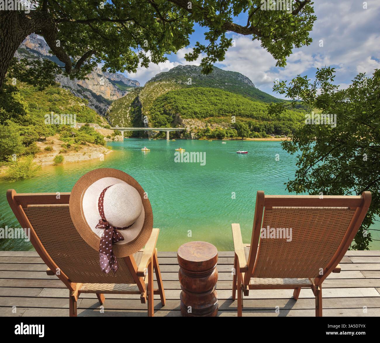 Travel to Provence. Two wooden chairs and straw hat on the platform at ...