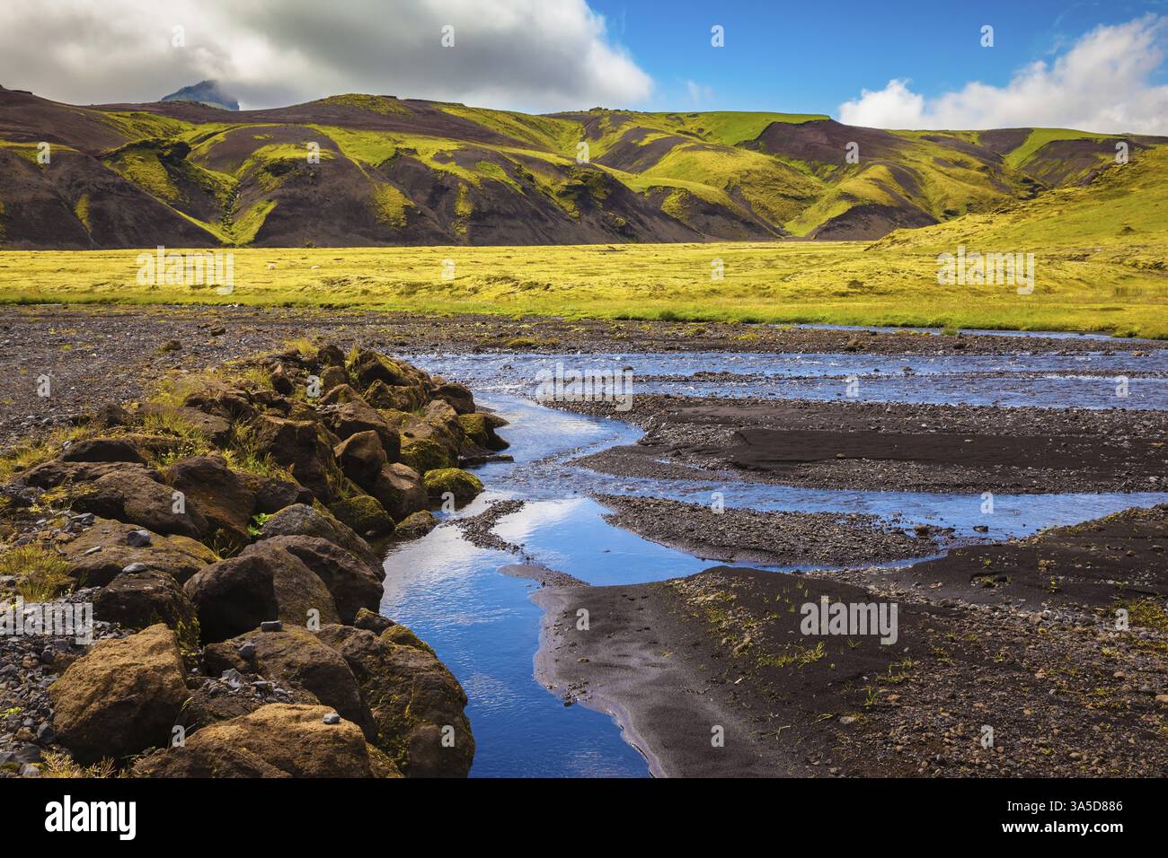 Picturesque basalt hills overgrown green grass and polar moss. On ...