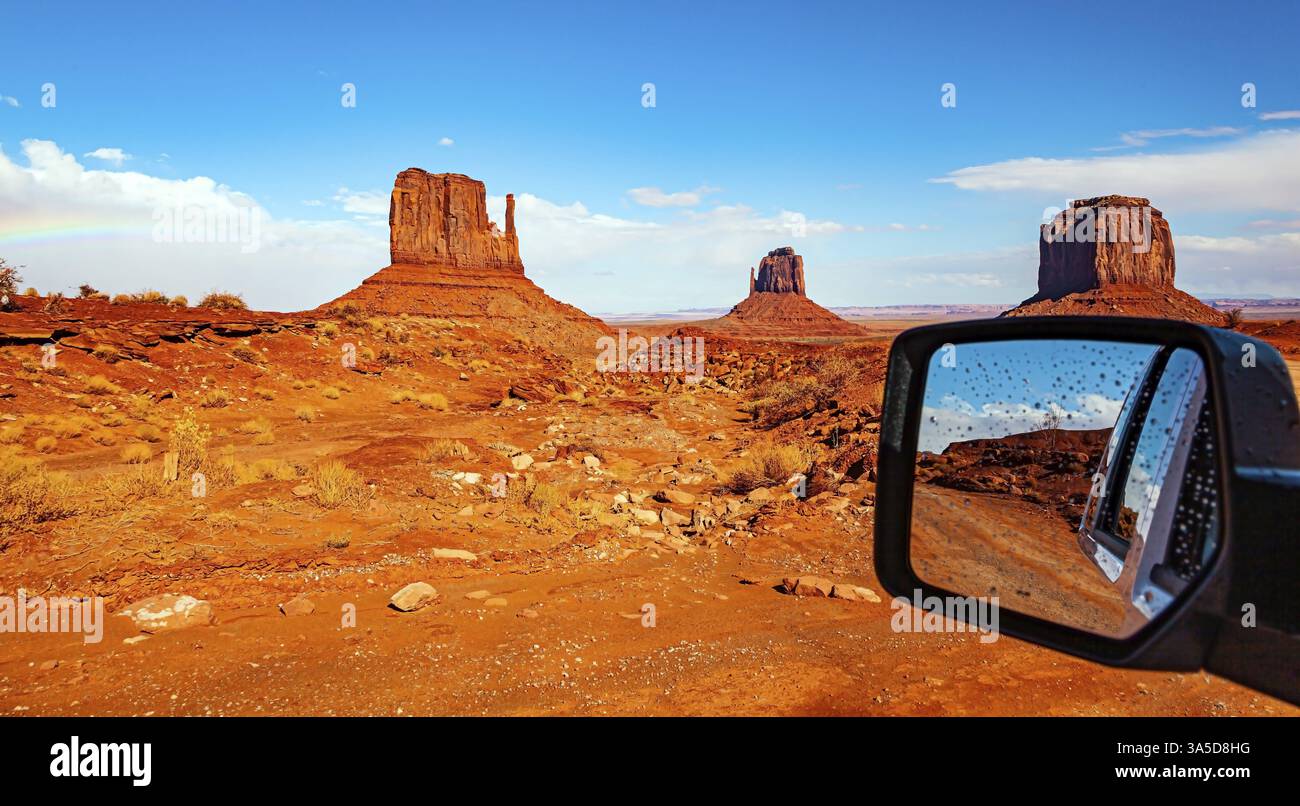 The car mirror reflects the scenic landscape. The famous rock Mitten ...