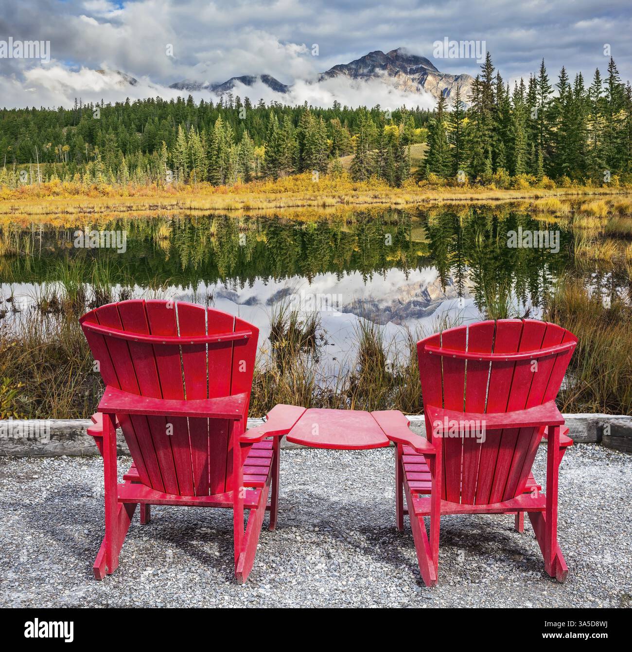 Jasper National Park in the Rocky Mountains. Two red plastic chairs ...