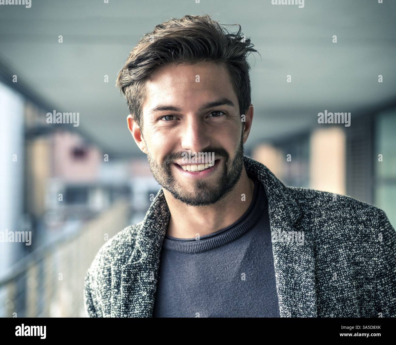 One handsome young man in urban setting in European city, standing and ...