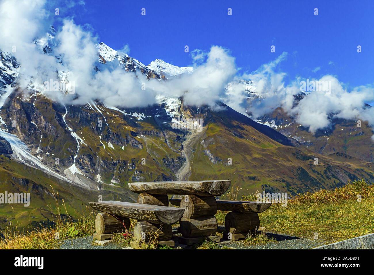 Snowy mountain peaks covered with clouds. The famous mountain road ...