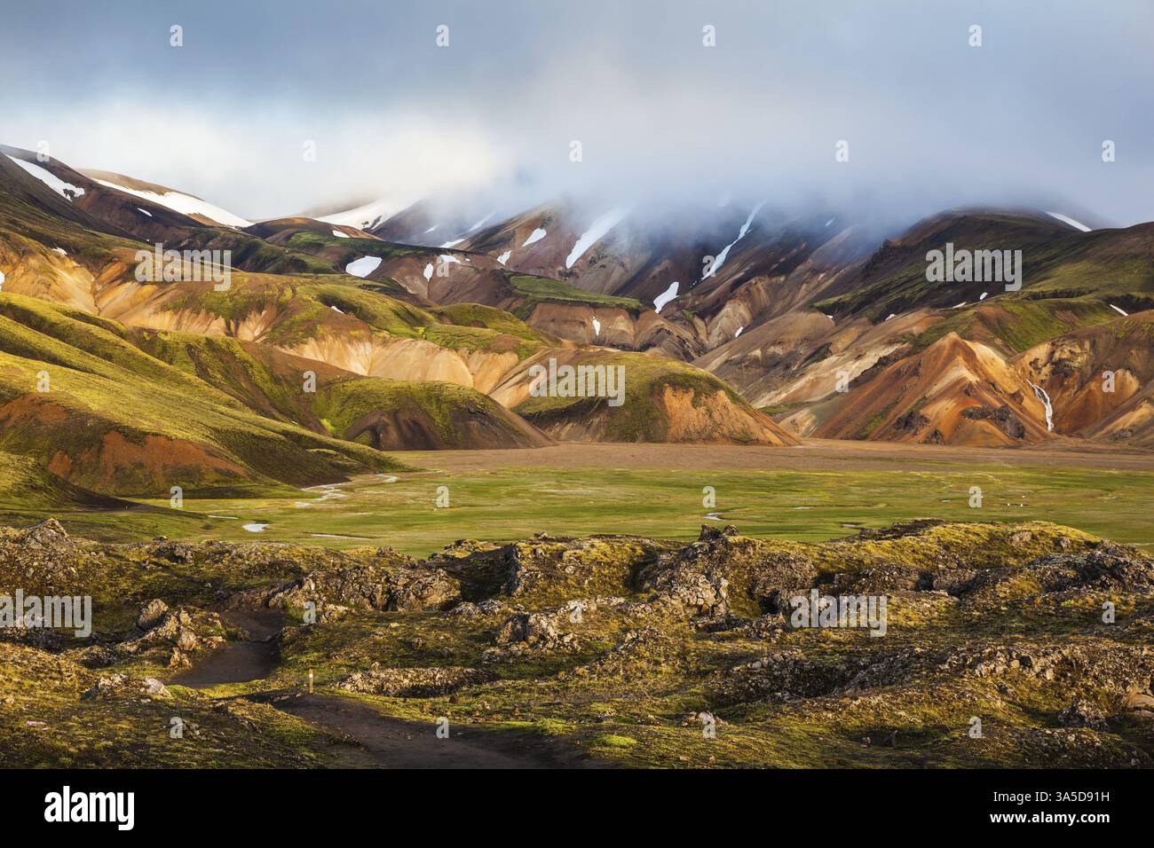 Pink dawn in the Arctic. Striped mountains of rhyolite covered sunshine ...