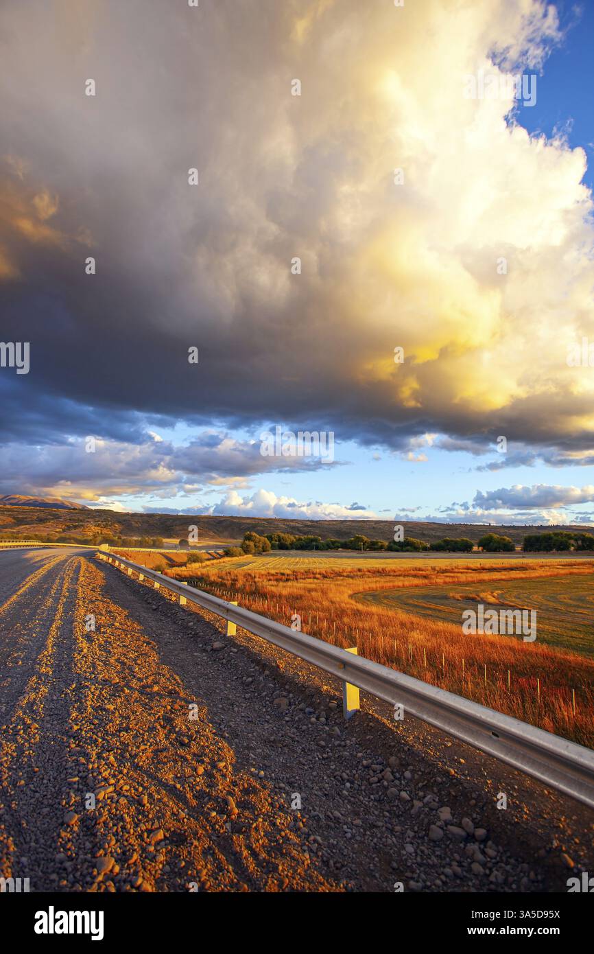 Gigantic scenic thundercloud illuminated by the sunset. The steppe is ...