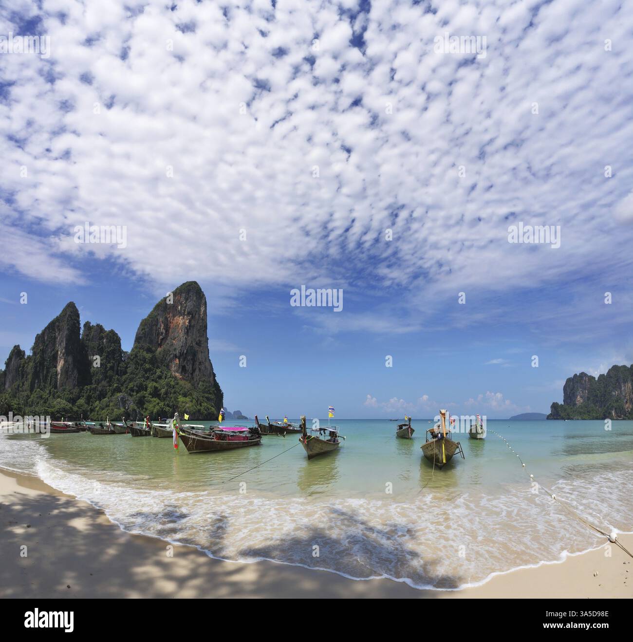 Light cirrus clouds over the warm sea. Picturesque native boat Longtail ...