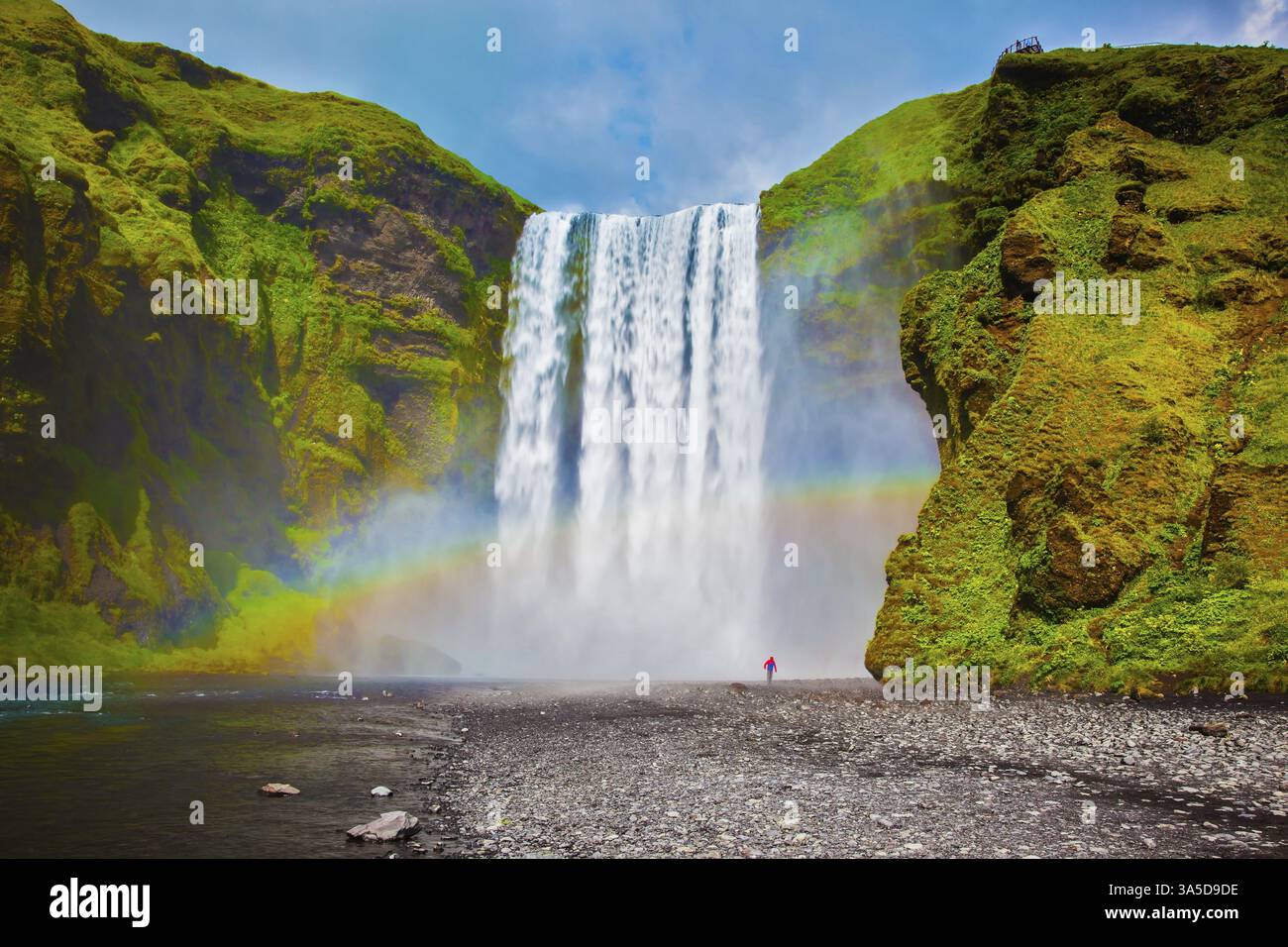 The most popular waterfall in Iceland - Skogafoss. Water rushes down ...