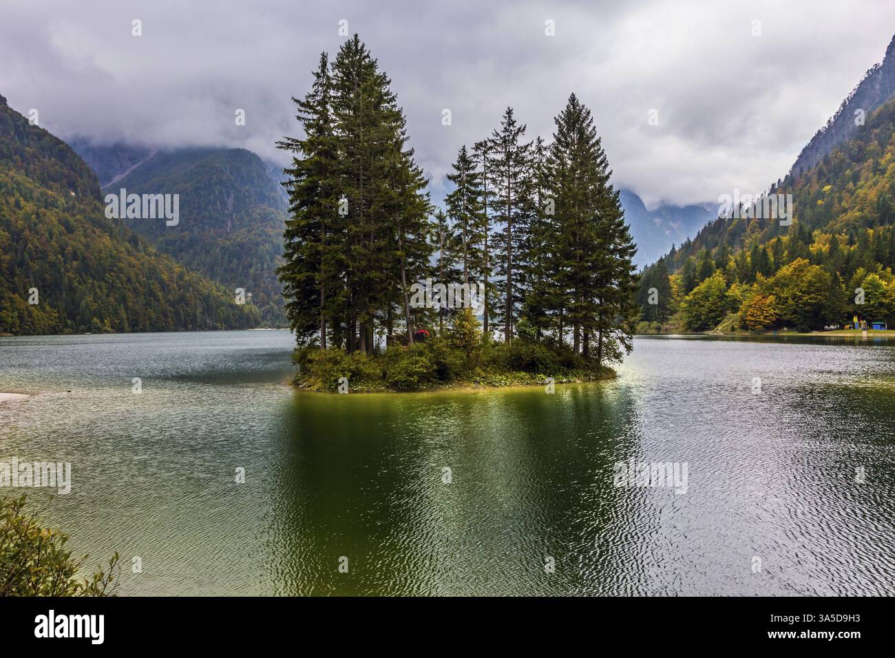 The surface of the lake Di Predil is covered with light ripples. Cold ...