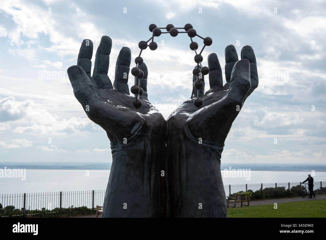 Ramsgate, UK. 22nd Mar, 2025. A man pushes his bicycle by the Hands and ...