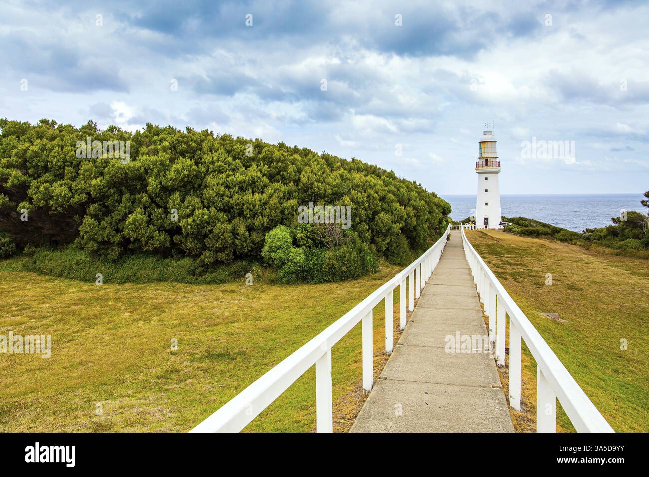 Magnificent lighthouse on the ocean shore. The Great Ocean Road runs ...