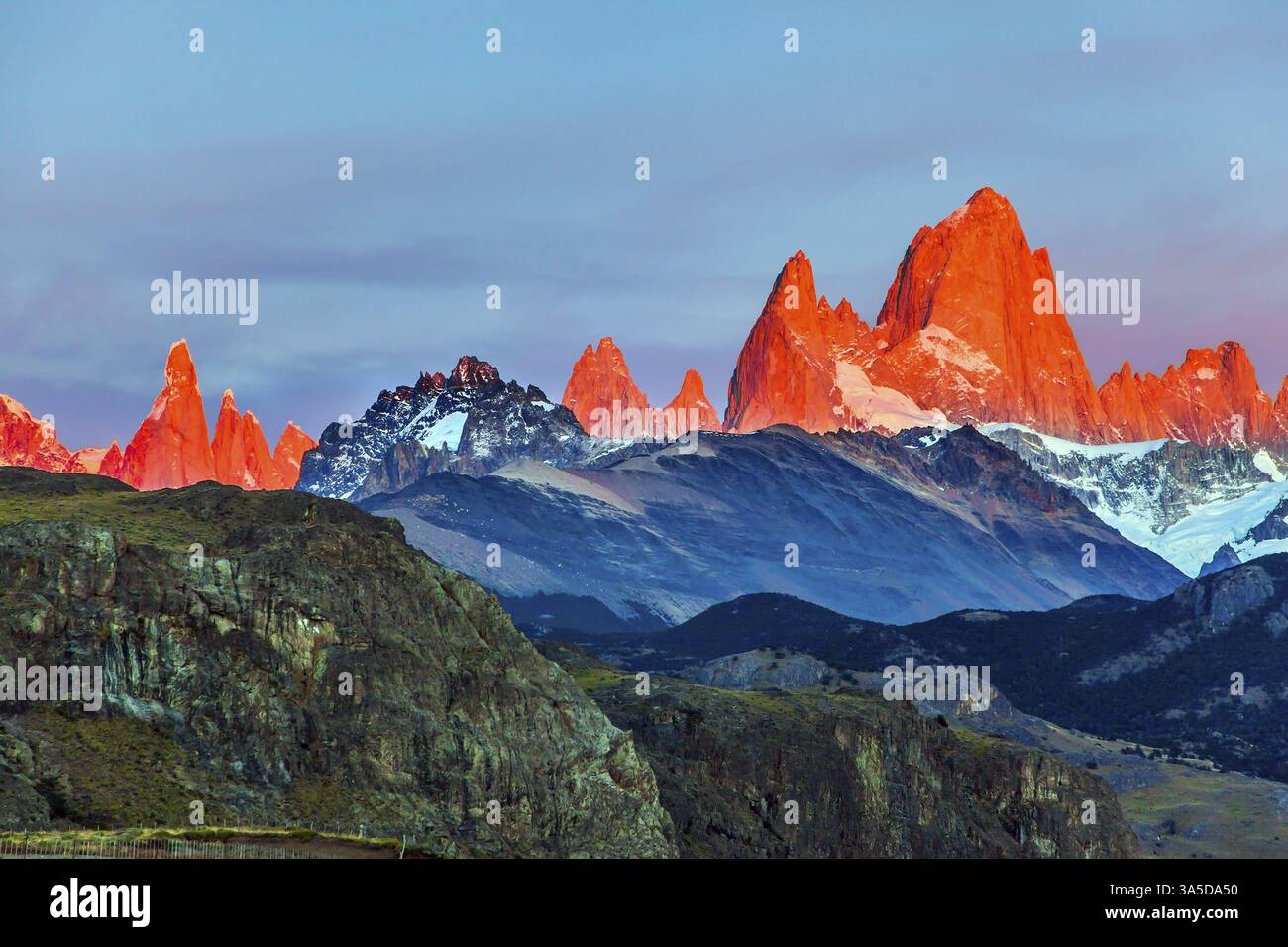 The grand crimson dawn over the mountain range Fitzroy. Mountain peak ...