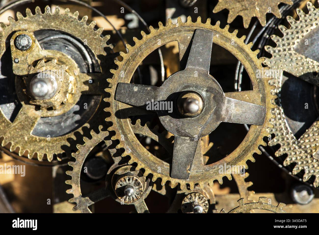 Close up metal gears mechanism. Golden colours. Hard light. Clock ...