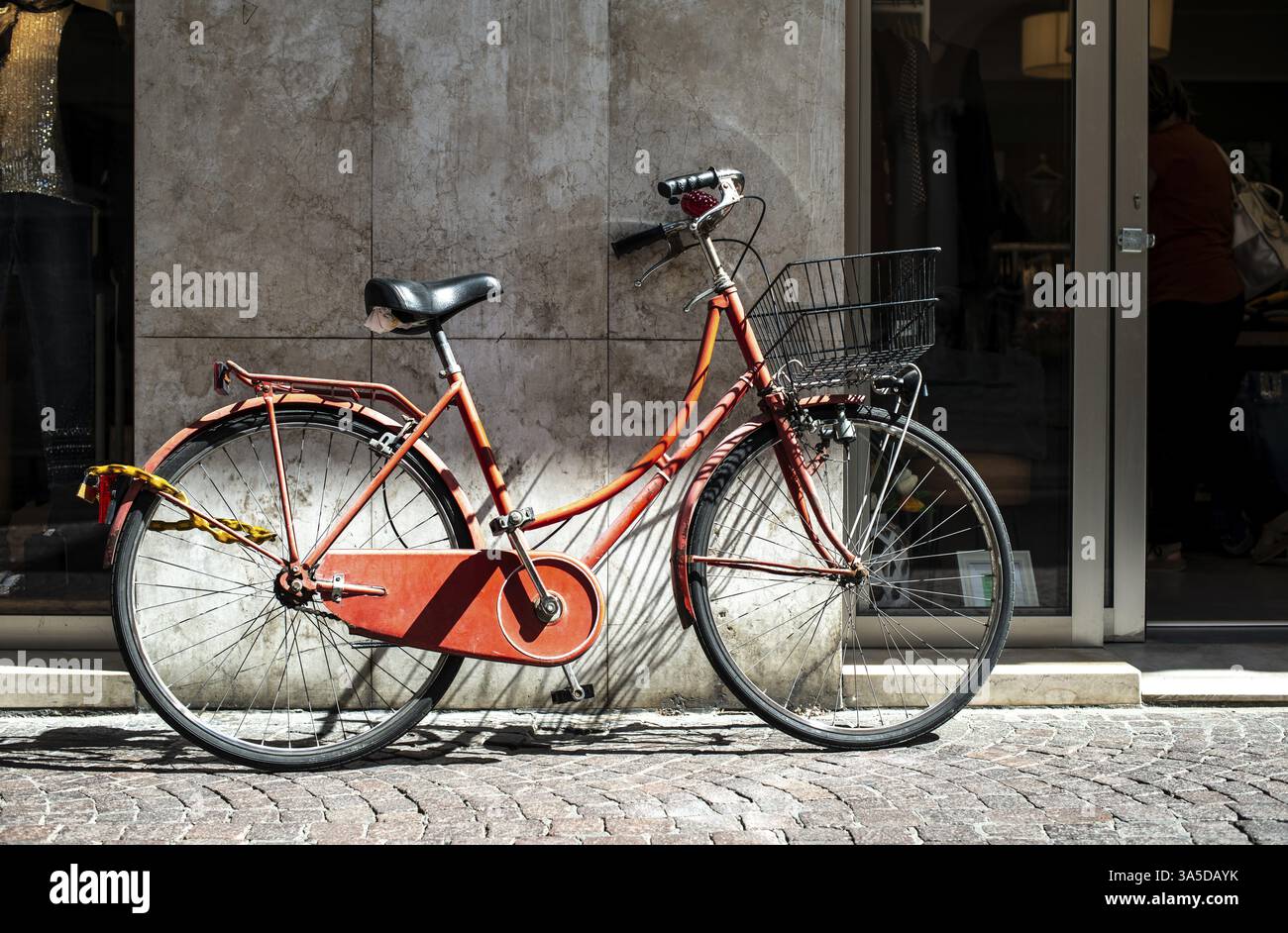 Red bike with basket on italian street. Typical italian architecture on ...