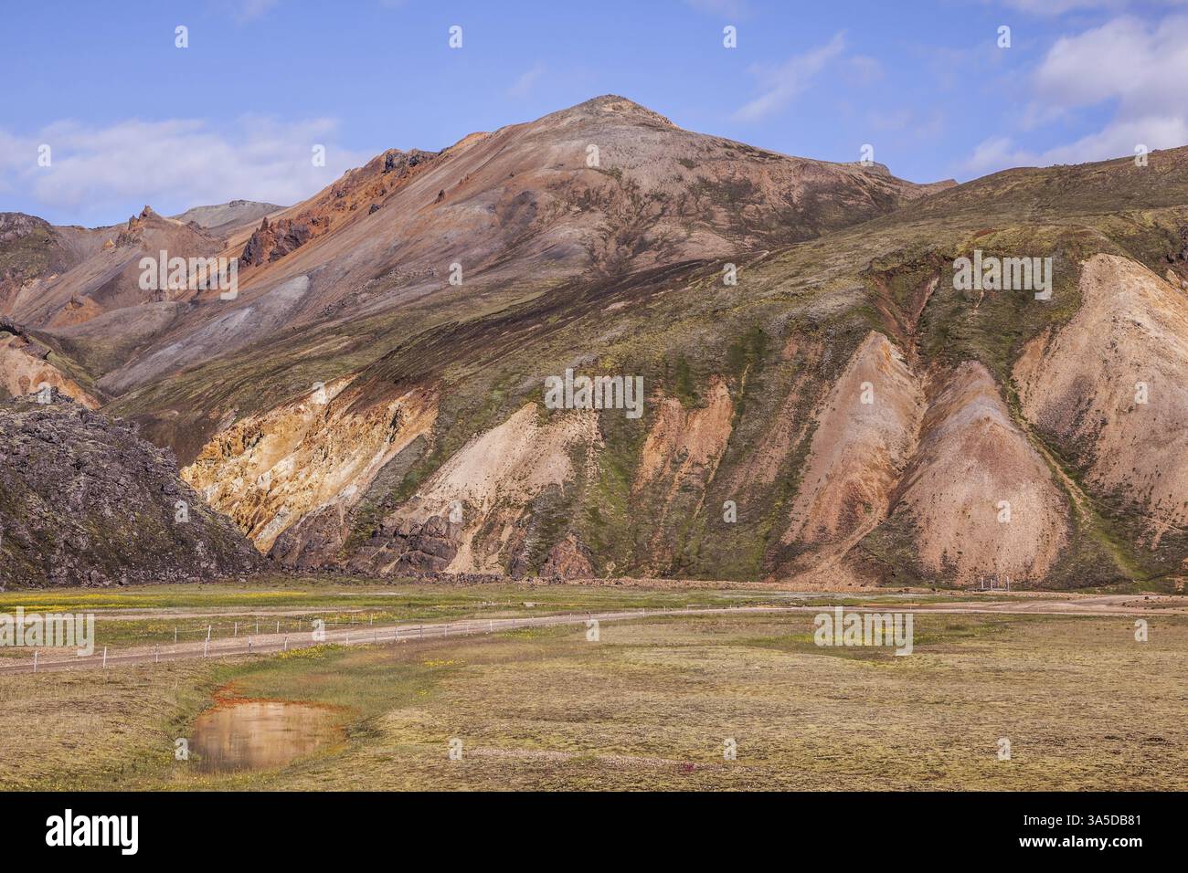 Pink and green rhyolite mountains surround the valley. Summer morning ...