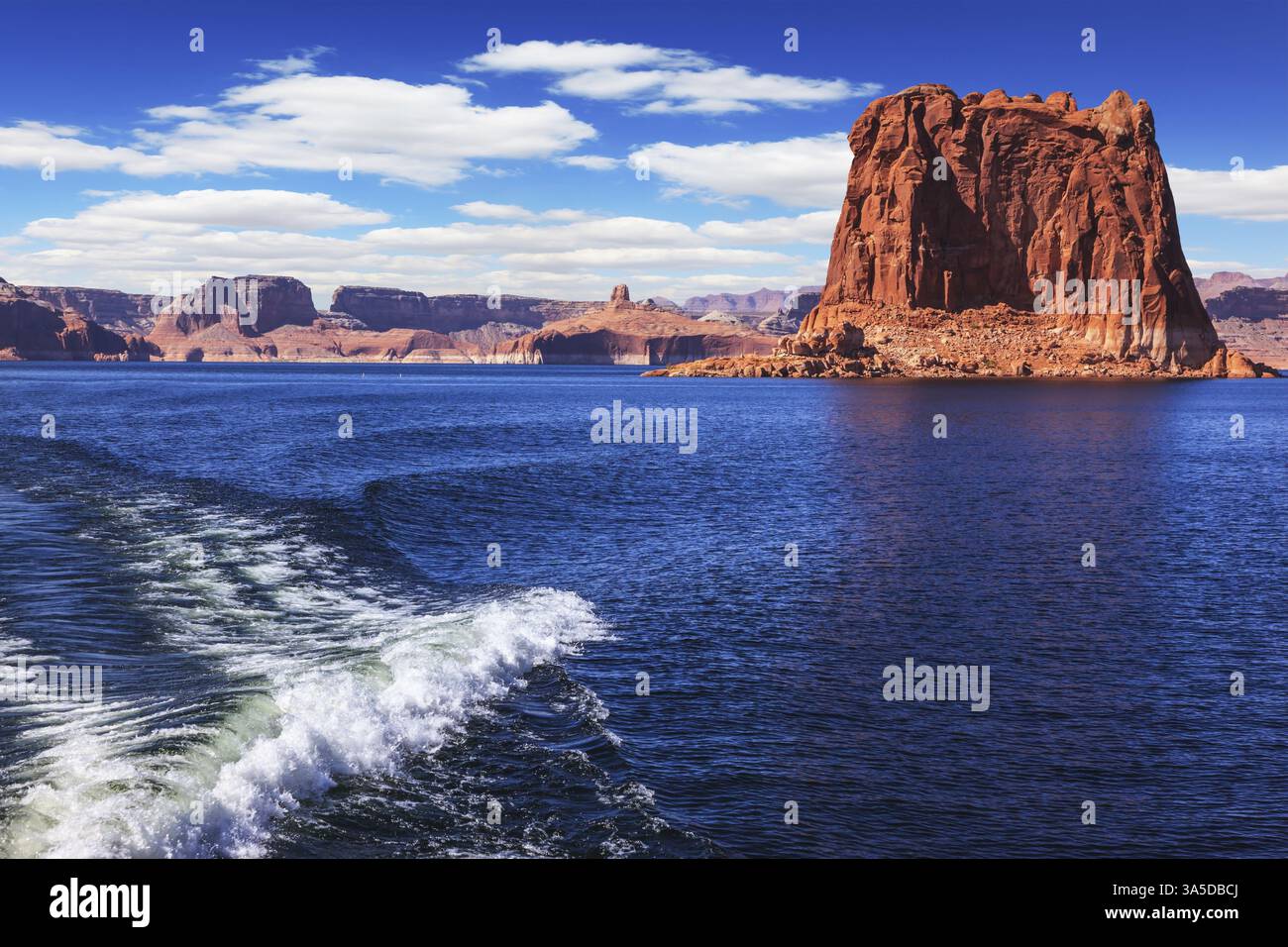 Foamy trace of a motor boat crosses the emerald waters. In the distance ...