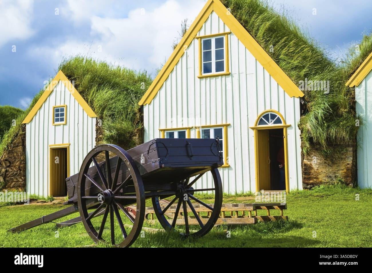 The ancient two-wheeled wooden cart on the front lawn. The village ...