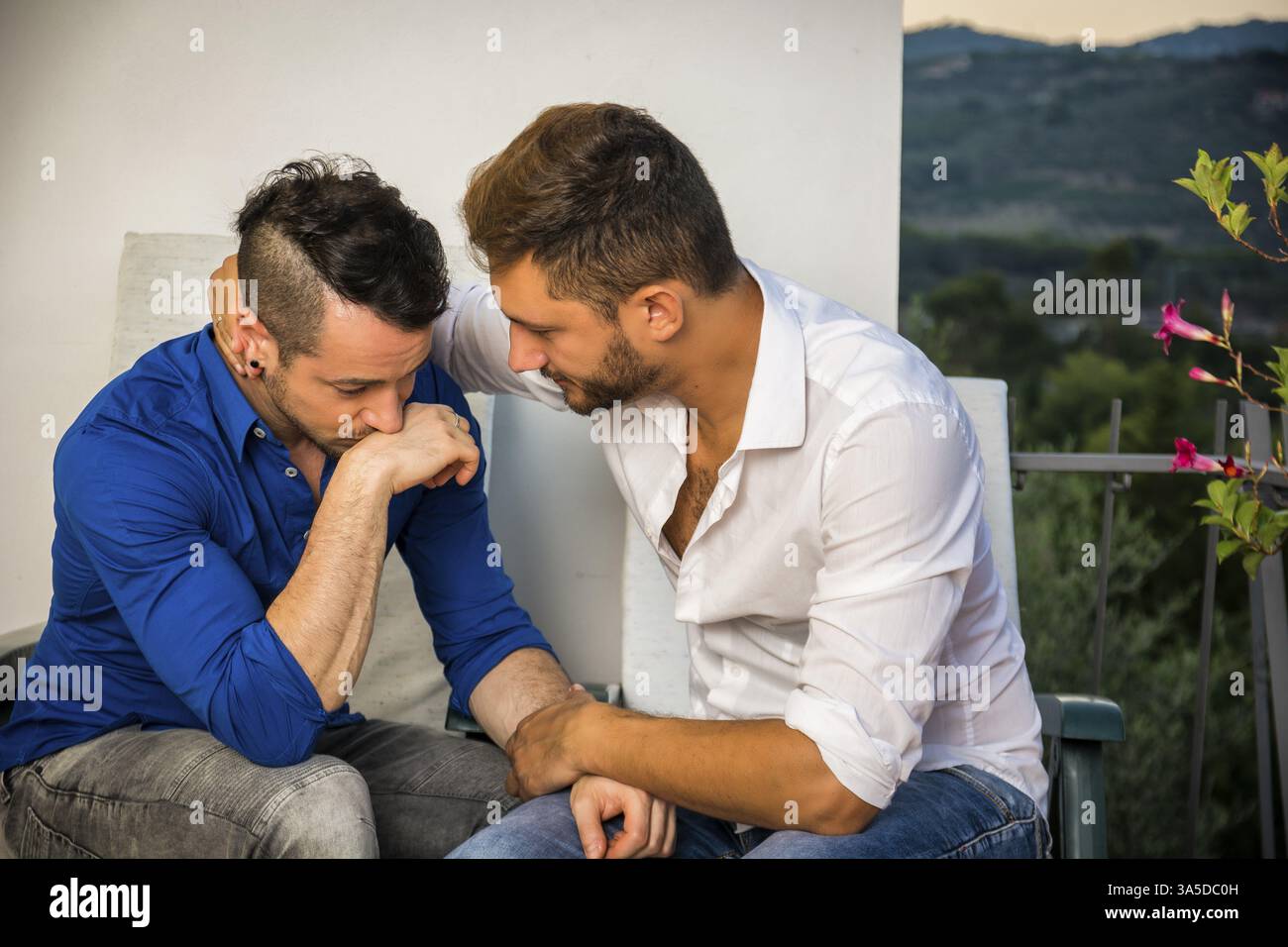 Handsome guy sits hugging hi-res stock photography and images - Alamy