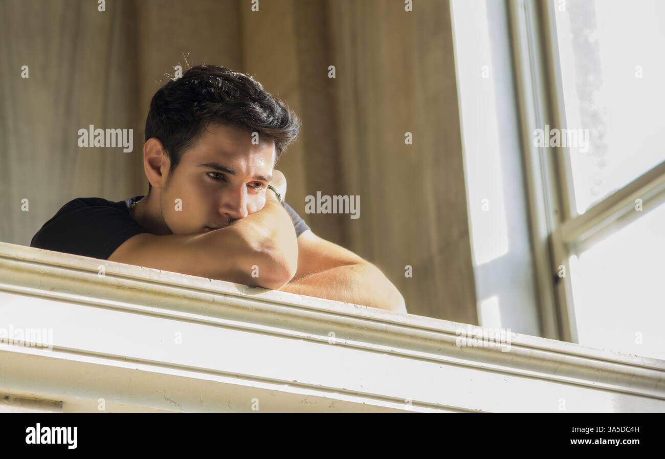Portrait of Shy Attractive Young Man Leaning on Folded Arms Against ...