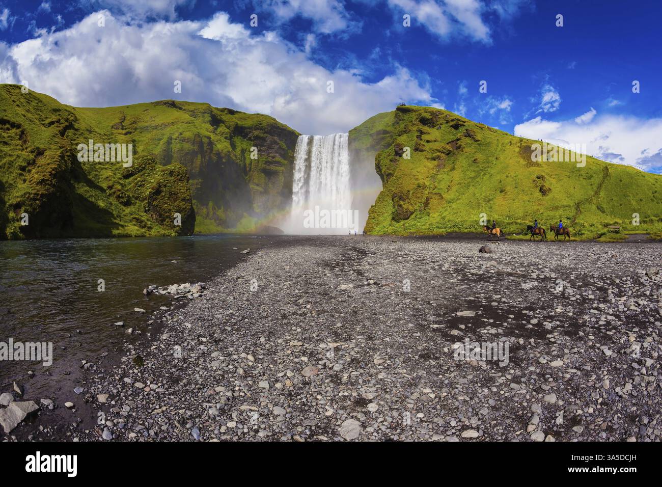 Horse tour to the waterfall Skogafoll summer. Huge picturesque ...
