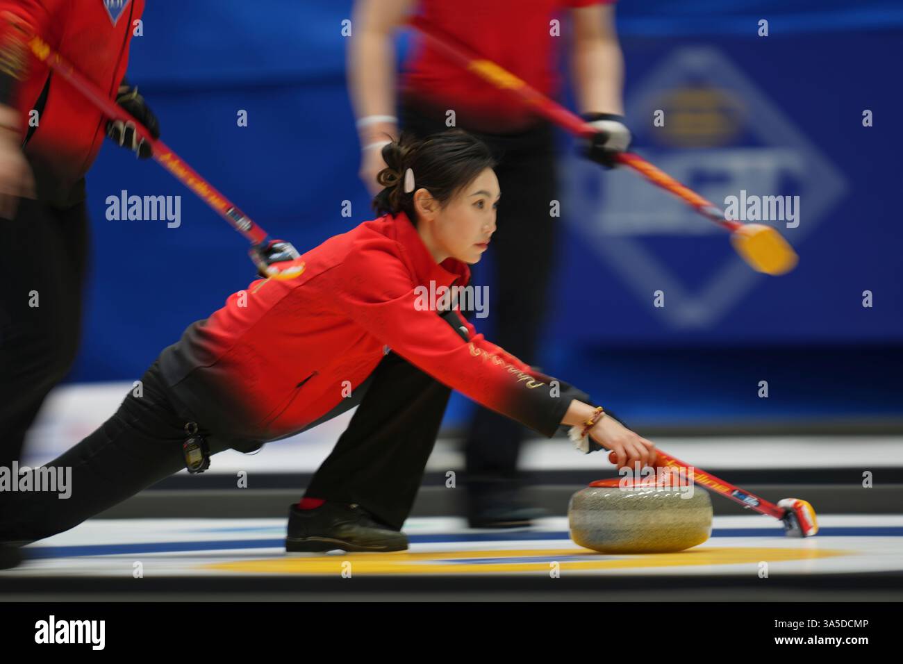 China's Jiang Jiayi releases the stone during the bronze medal match against South Korea at the ...