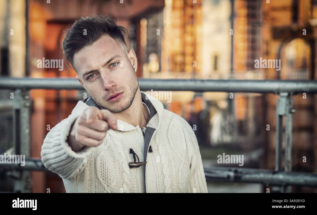 Handsome young man pointing fingers at you, towards the camera, with ...