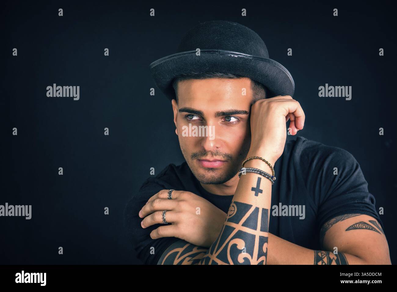 Handsome and stylish young man with black bowler hat and t-shirt. Cool ...