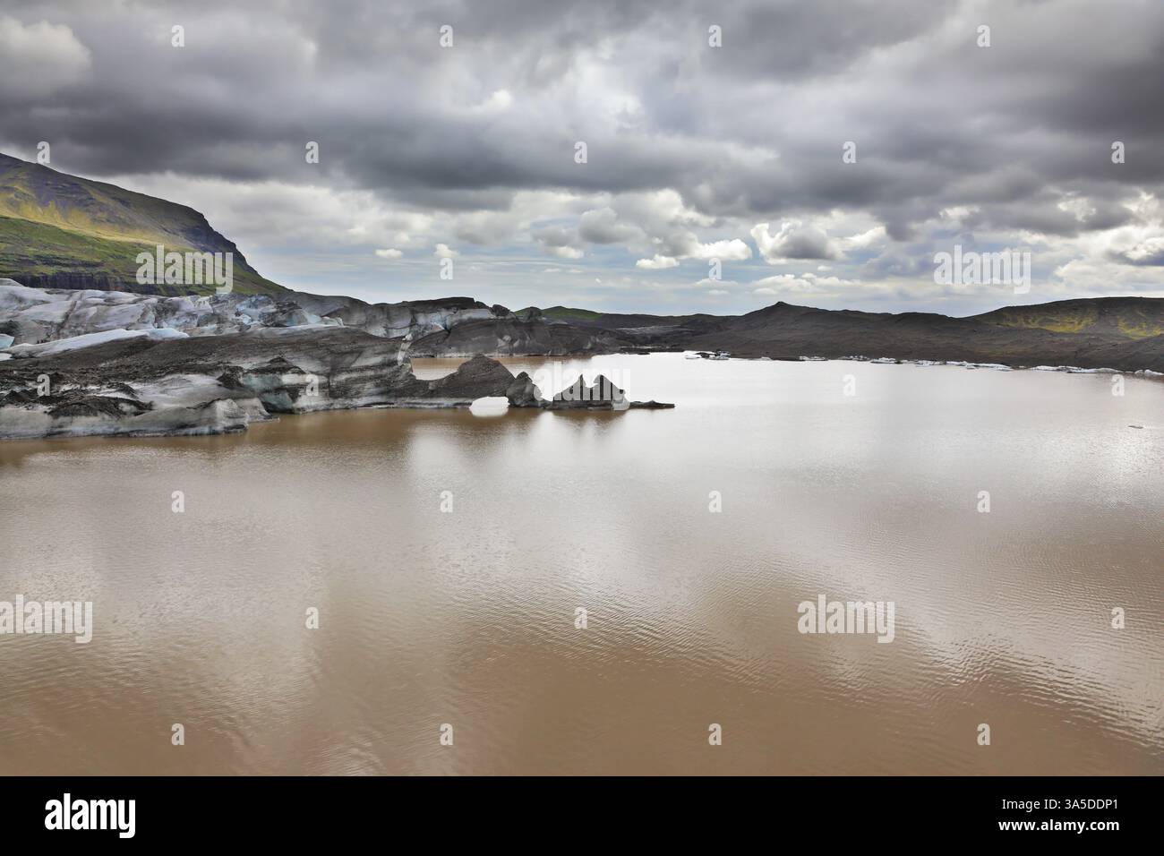 Skaftafell National Park. Ice covered with volcanic ash. Mirror Lake ...