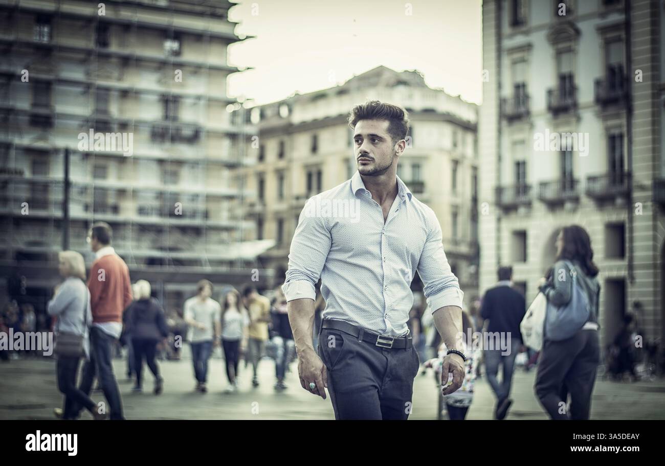 One handsome elegant young man in urban setting in European city ...