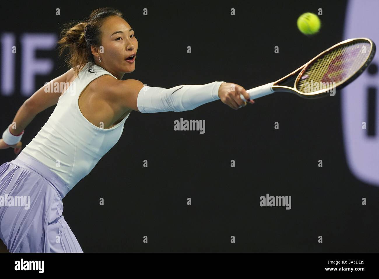 Qinwen Zheng of China hits a return to Taylor Townsend during the Miami ...