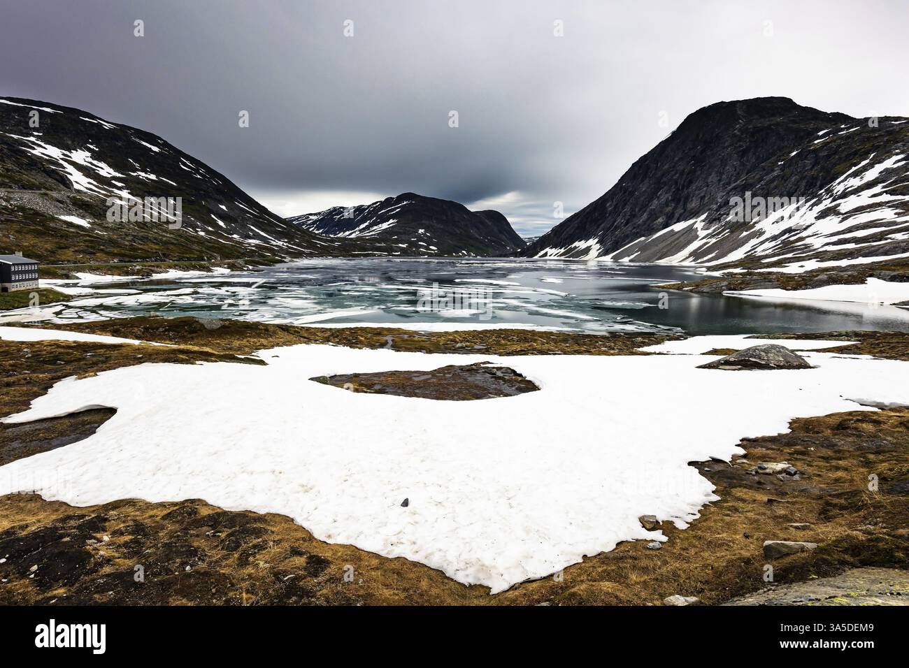 Semi-frozen lake Djupvatnet in the mountains of Northern Norway. Frozen ...