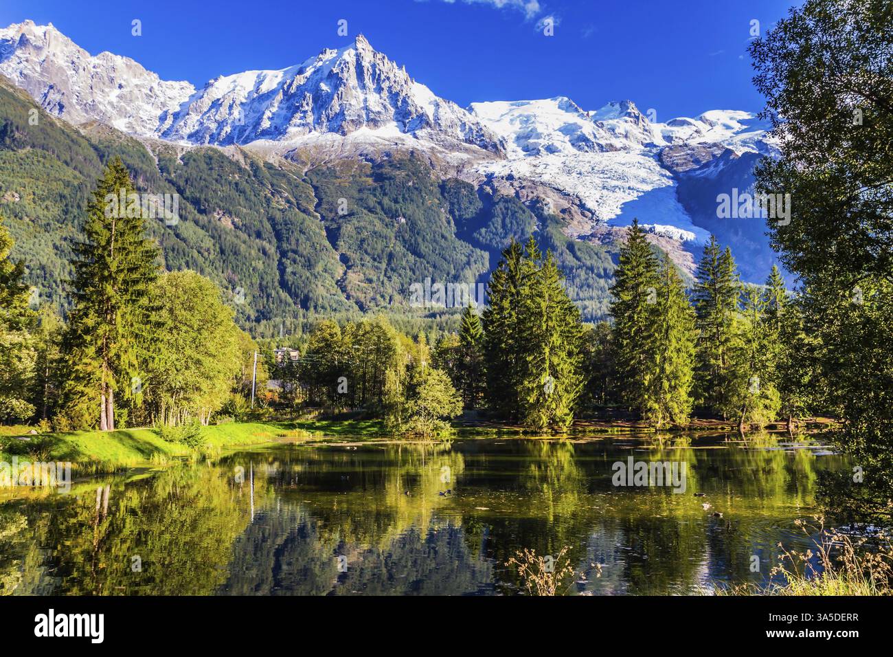 City Park is illuminated by the sunset. The mountain resort of Chamonix ...