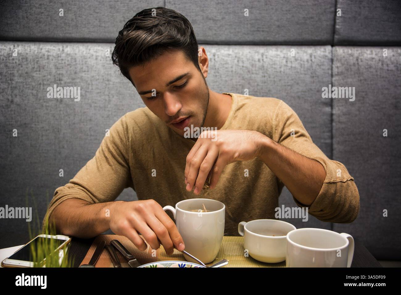 Attractive Young Man Eating Breakfast, Having some Cereal with Milk or ...