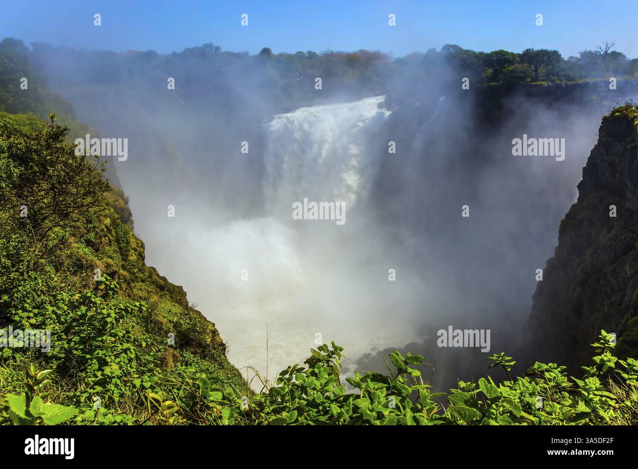 The waterfall Victoria Falls located on the Zambezi River. Giant cloud ...