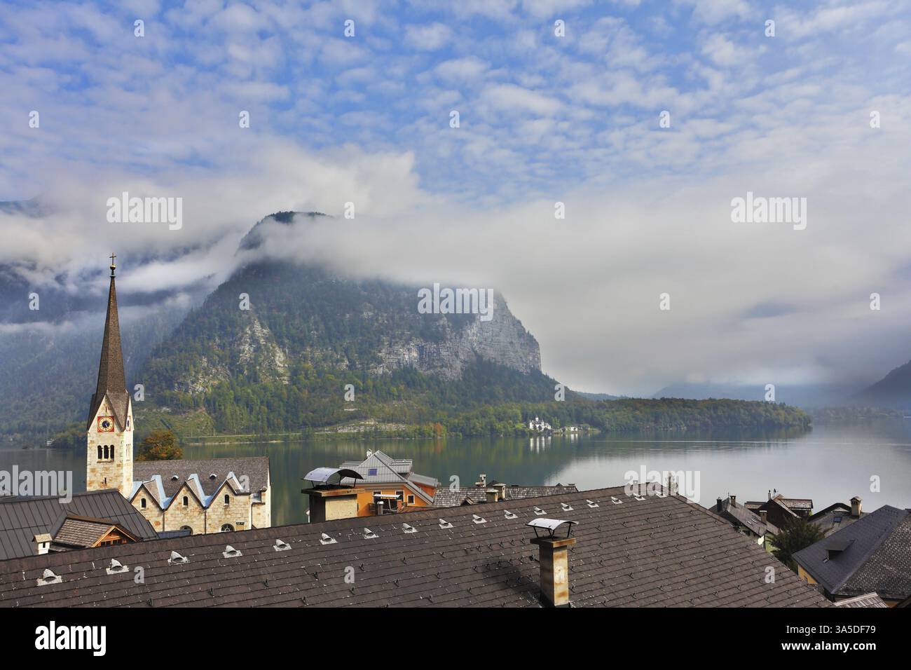 The most picturesque small town in Austria - Hallstatt. Slender bell ...