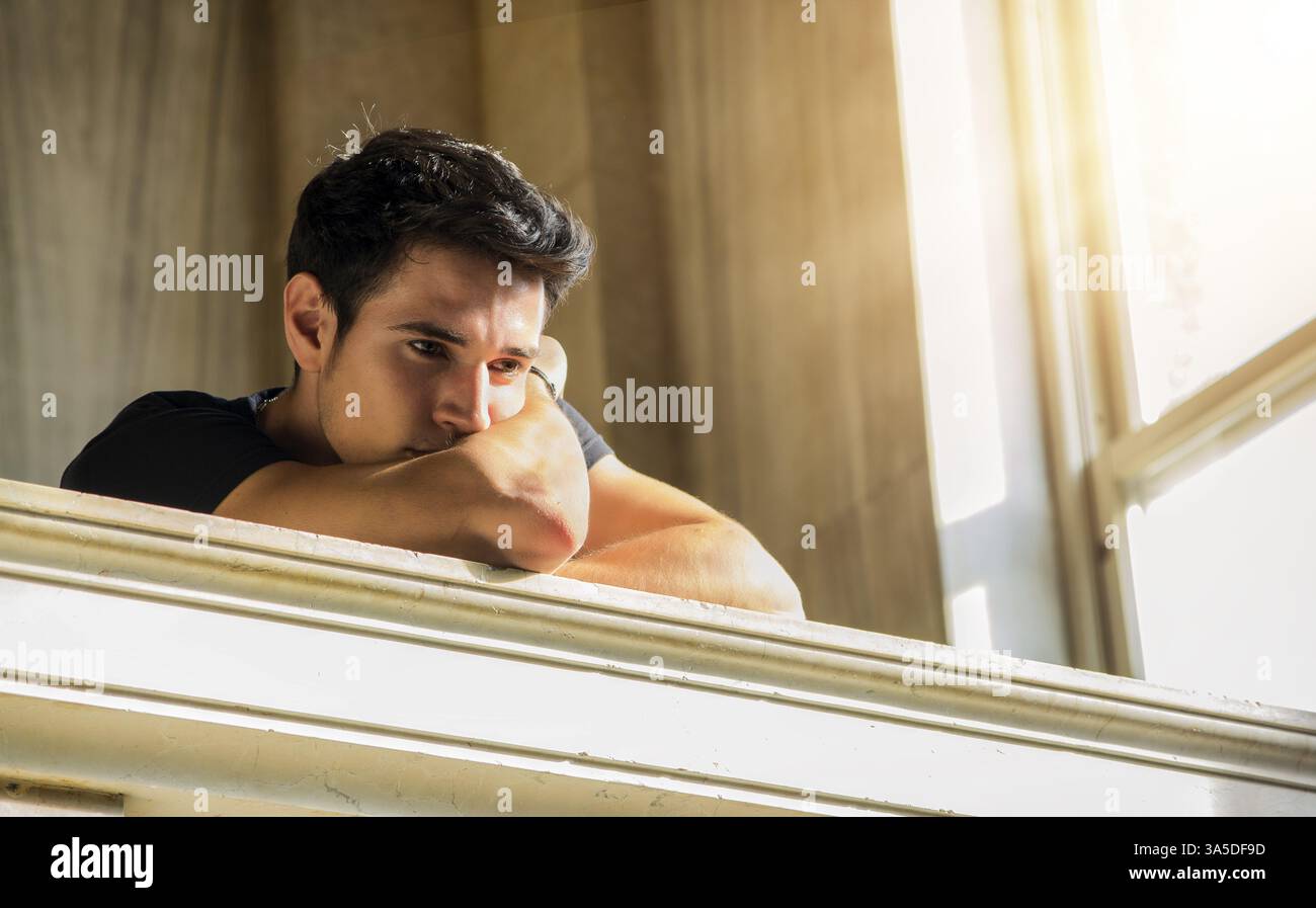 Portrait of Shy Attractive Young Man Leaning on Folded Arms Against ...