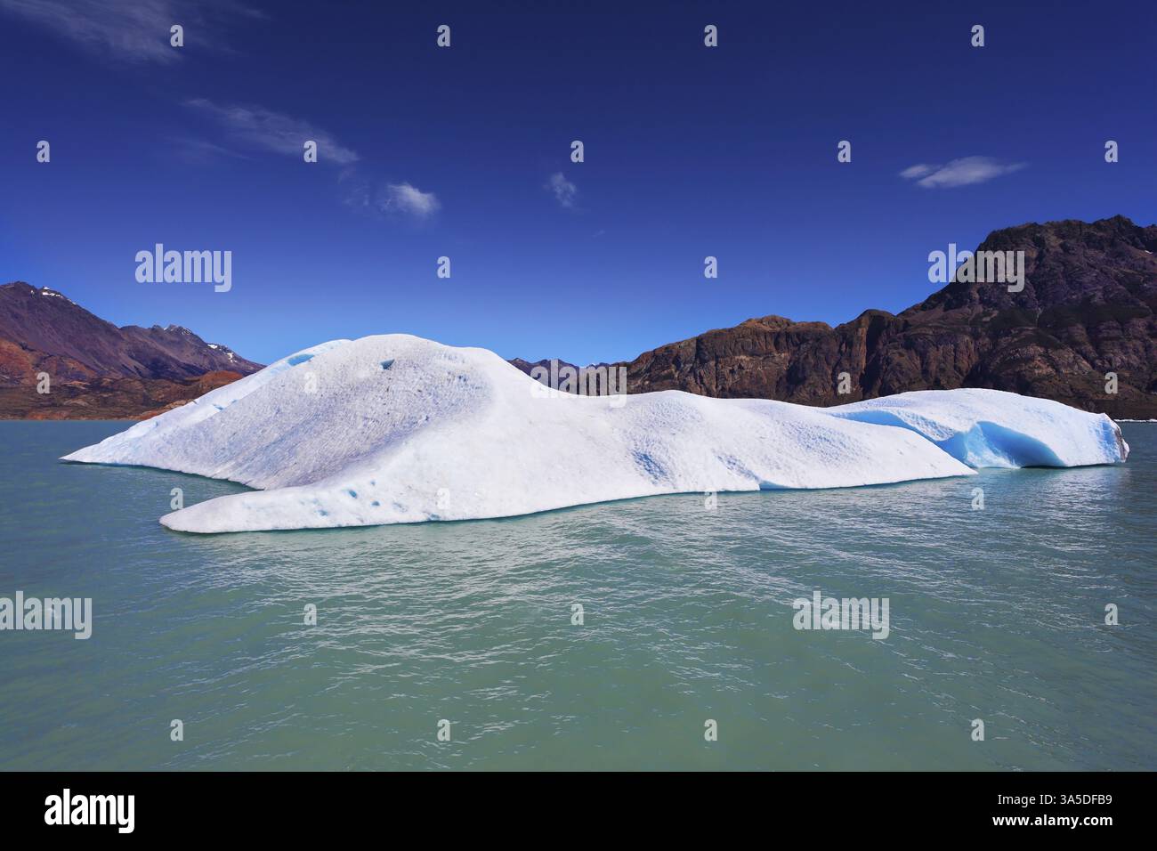 Huge white-blue icebergs float in ice emerald waters of the lake in ...
