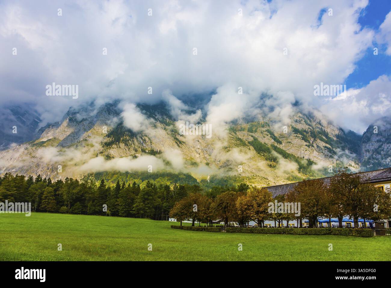Magnificent snowy mountain peaks surround the lake. Alley along the ...