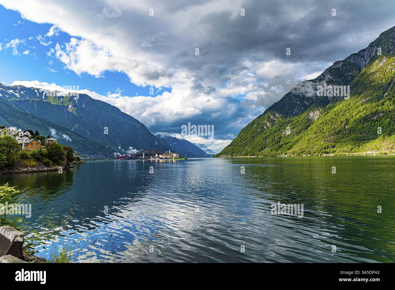 Small town of Odda. Magical late summer sunset illuminates the city and ...