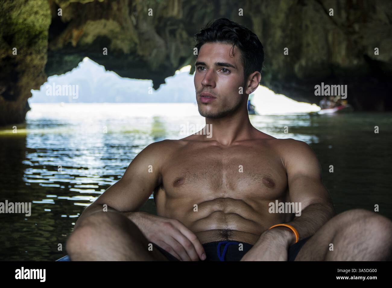 Rear view of a man on a raft relaxing drifting along the river in ...