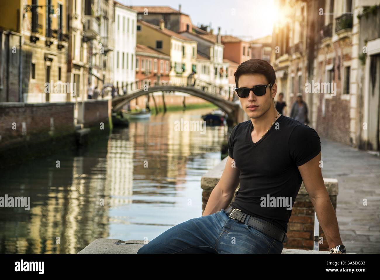 Portrait of Attractive Dark Haired Young Man Leaning Against Railing on ...