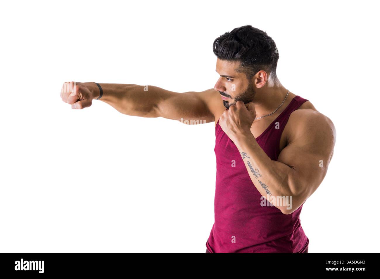 Muscular man throwing punch, isolated on white background in studio ...