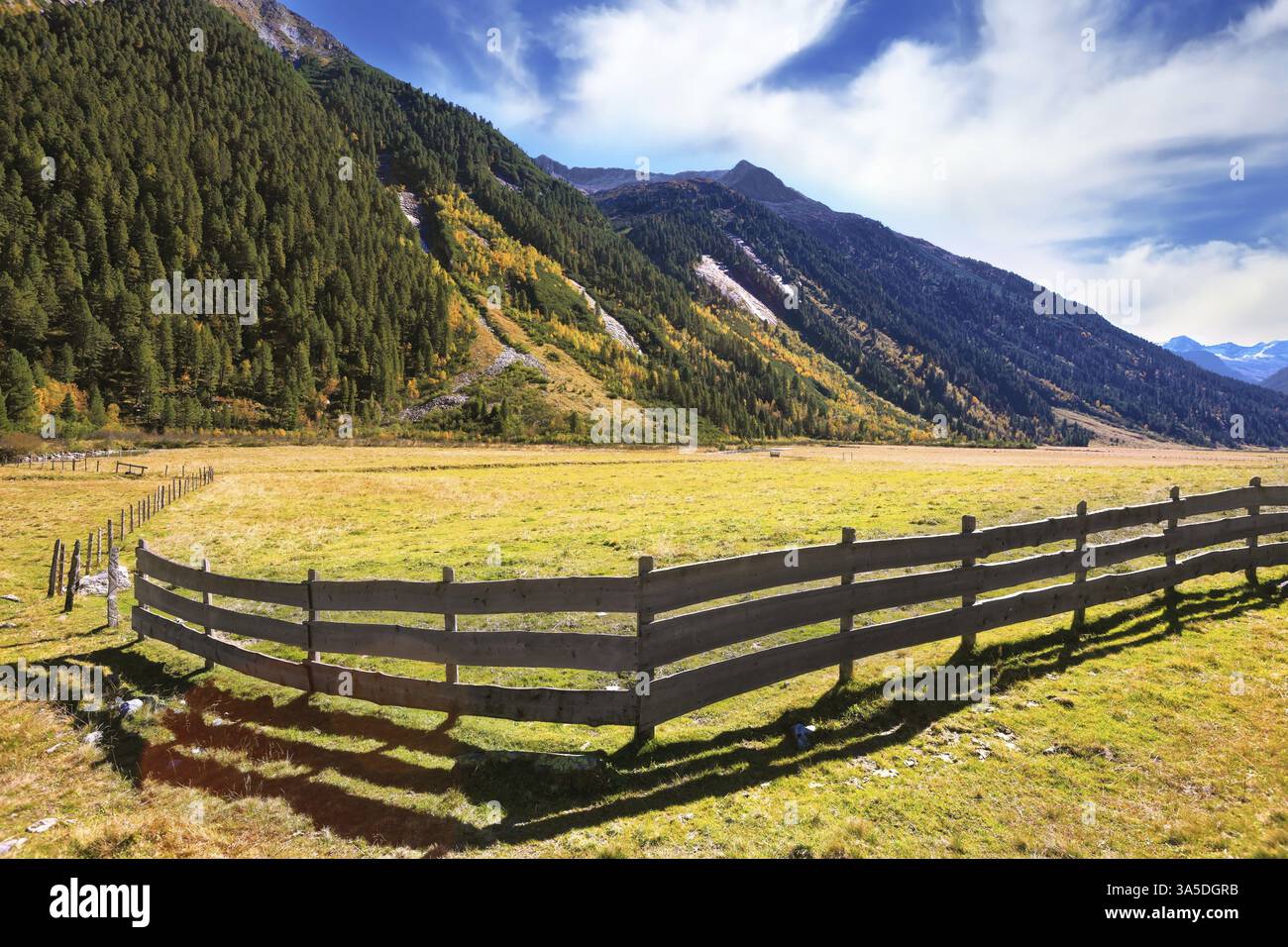 The beautiful autumn day in the Austrian Alps. Farmers alpine meadows ...