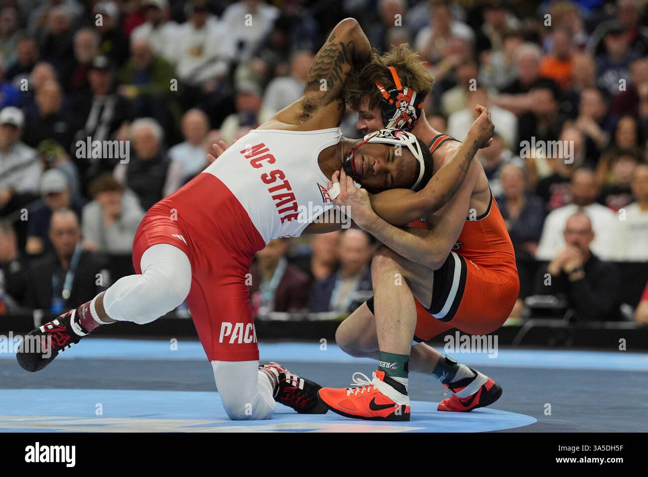 North Carolina State's Vincent Robinson, left, takes on Oklahoma State ...