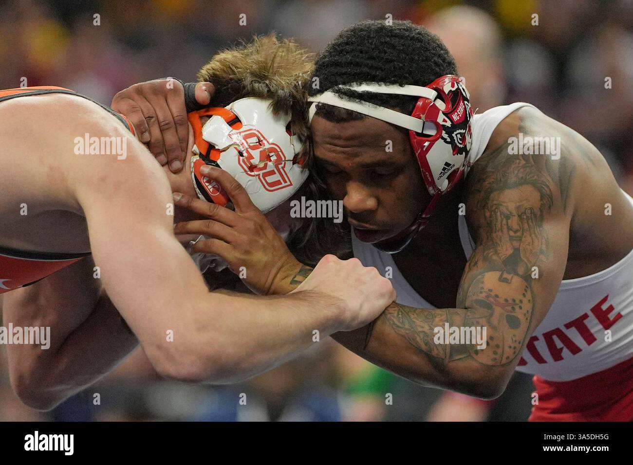North Carolina State's Vincent Robinson, right, takes on Oklahoma State ...