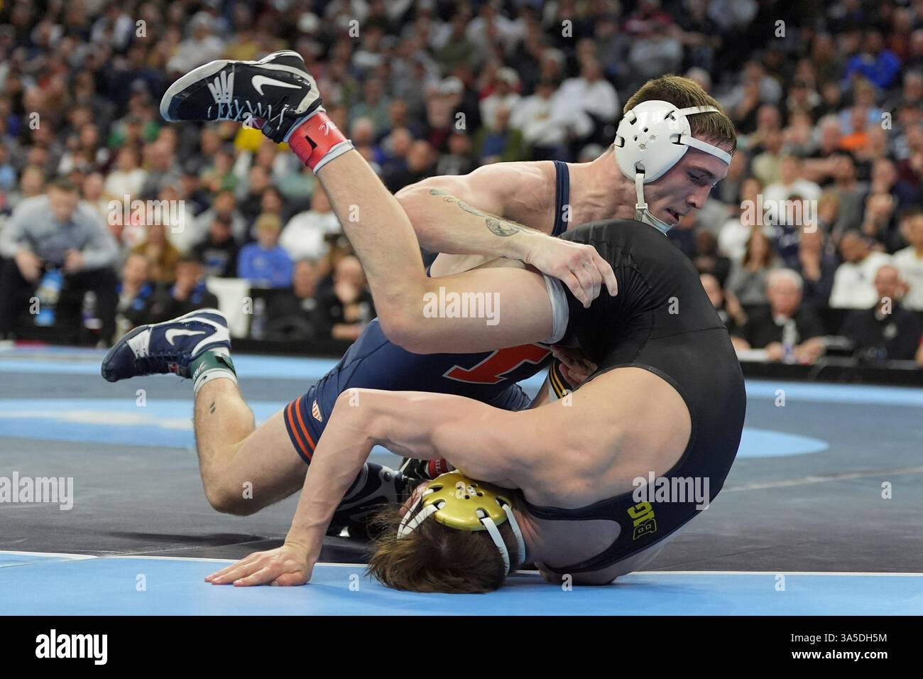 Illinois' Lucas Byrd, top, takes on Iowa's Drake Ayala in their 133 ...