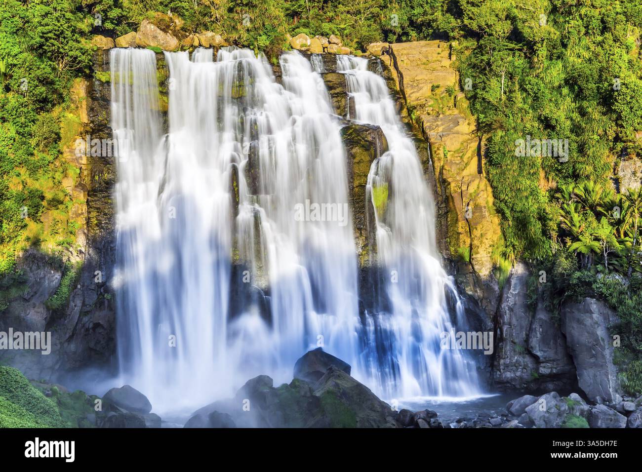 Concept of active and ecological tourism. Marokopa falls at sunset. Exotic journey to the North ...