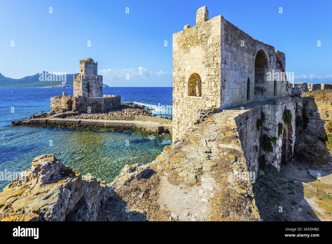 The three-tiered watchtower is built on long cape in the sea. Venetian ...